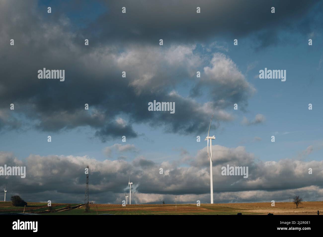 cloudy landscape with wind turbines and fields Stock Photo - Alamy