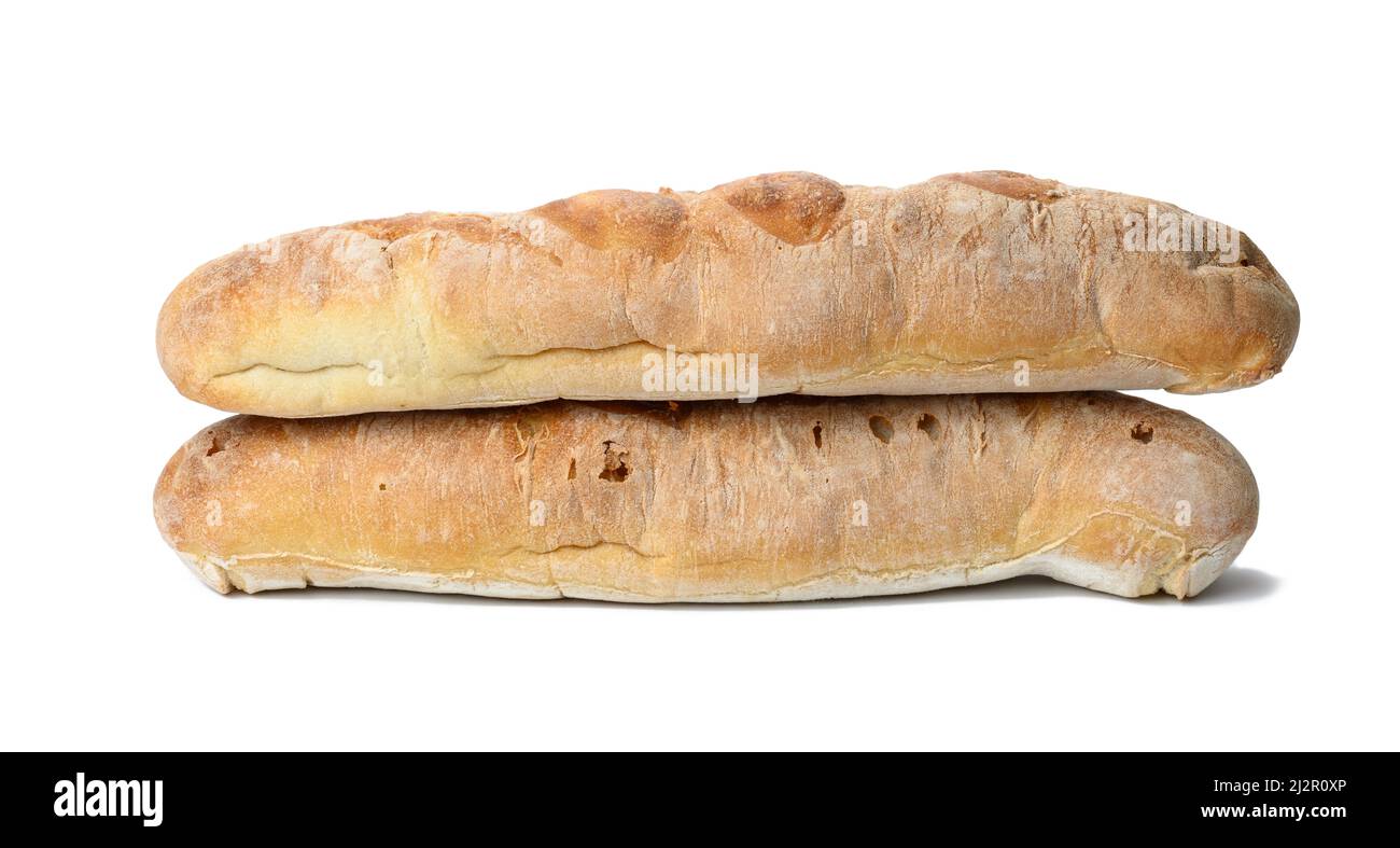 two baked baguettes made from white wheat flour on a white background ...