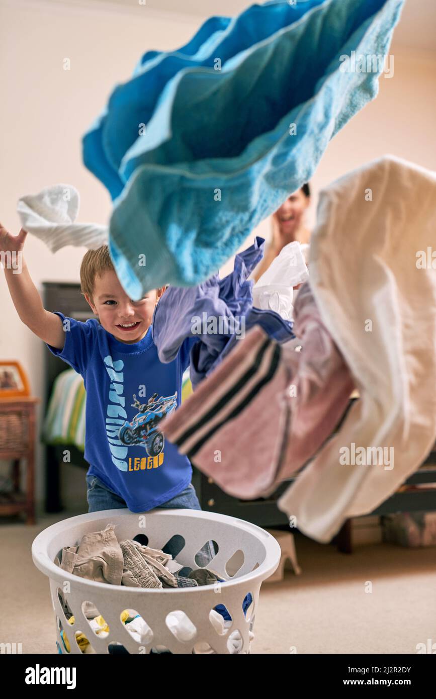 This is so much fun. Portrait of a little boy throwing laundry in the ...