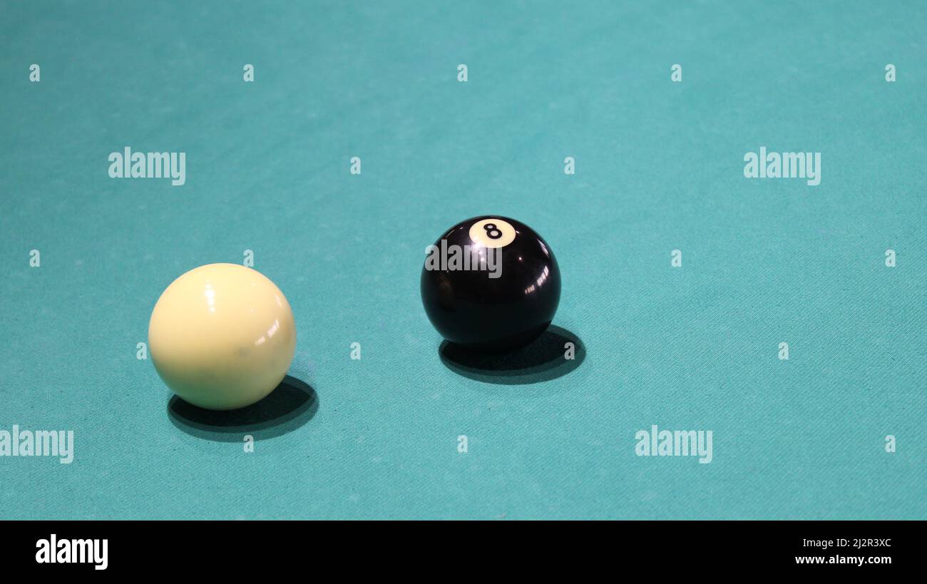 Black eight-ball on a blue table fascinating game Stock Photo - Alamy