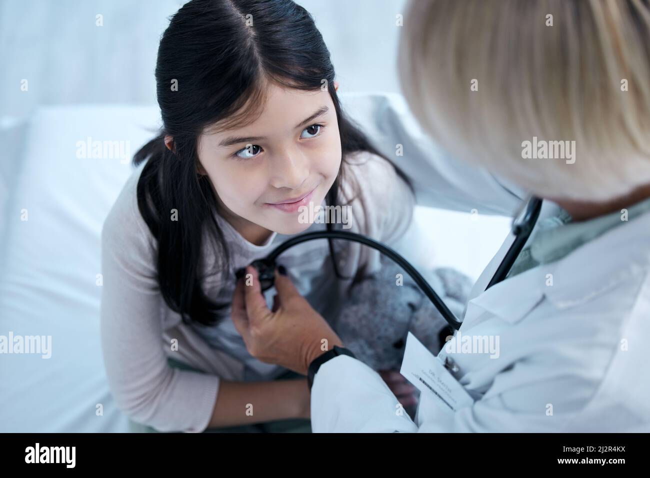 Happy and healthy. Shot of a little girl getting a checkup at the ...