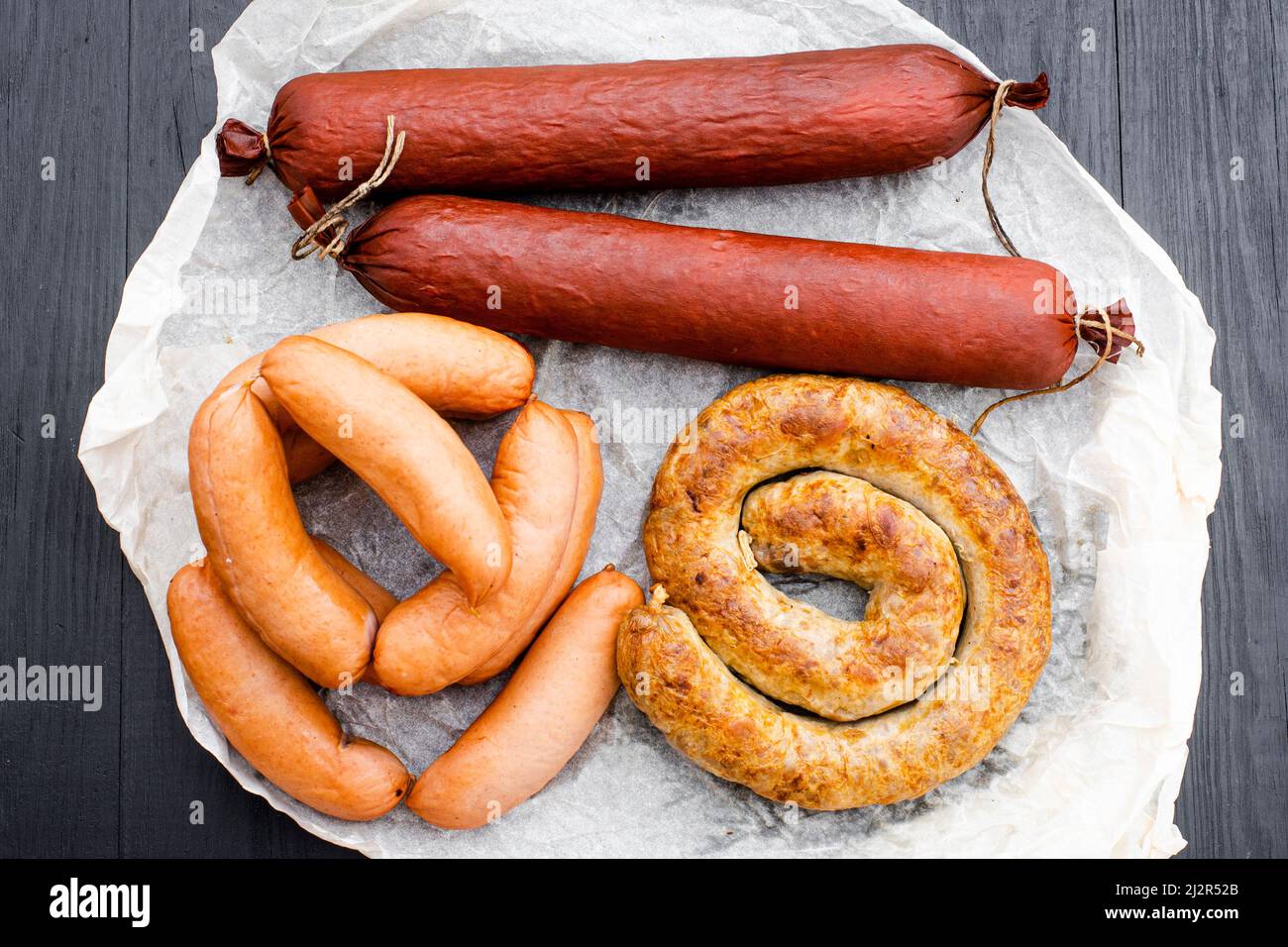 Different types of natural sausages on a wooden background Stock Photo ...