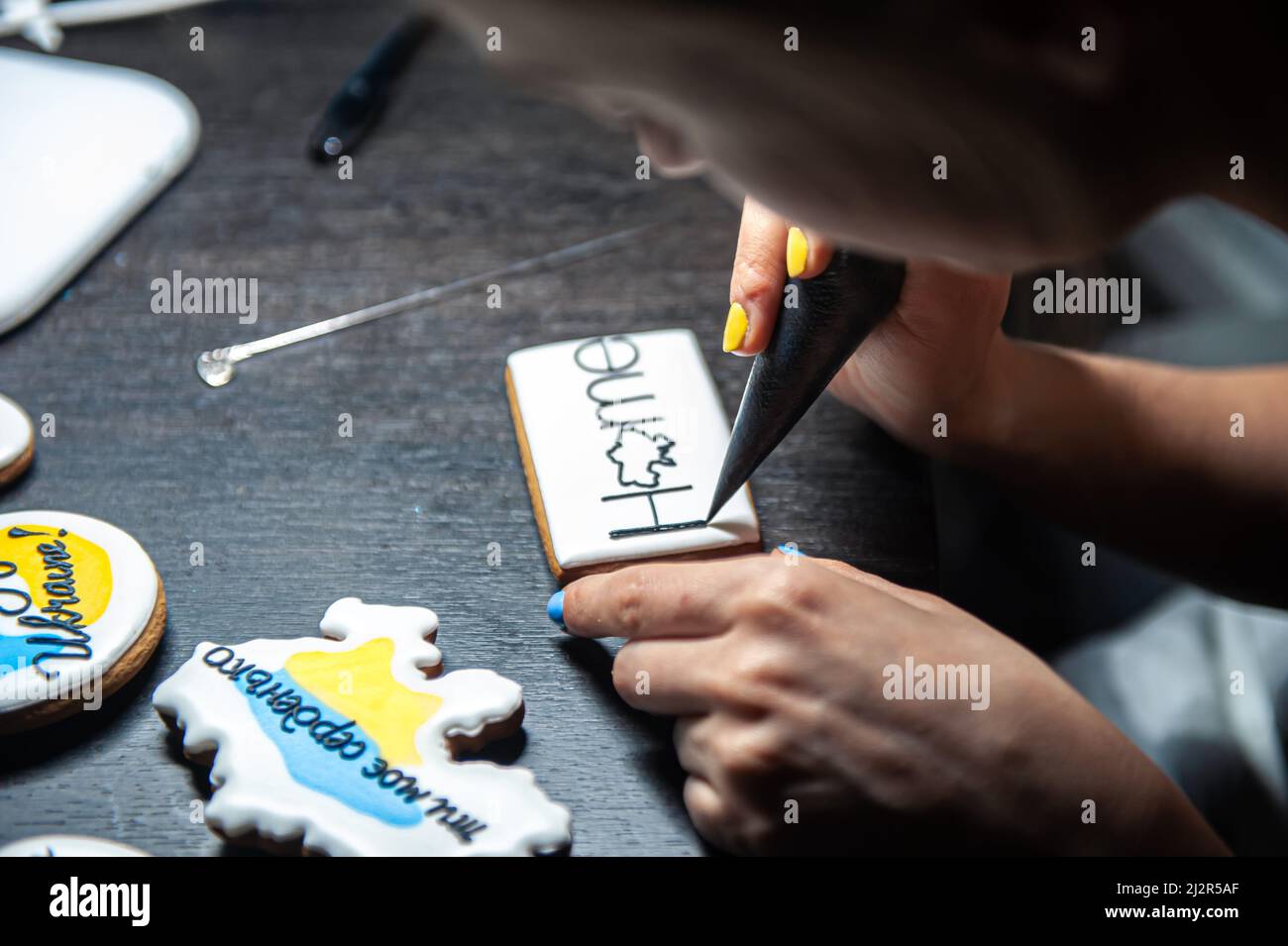 A woman makes patriotic gingerbread in support of Ukraine Stock Photo ...