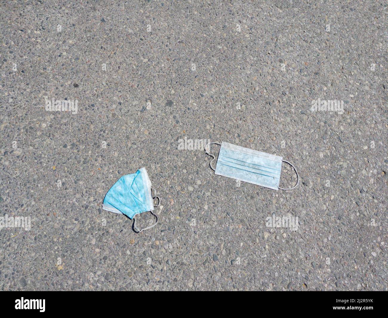 Dirty used face masks thrown away on ground Stock Photo - Alamy