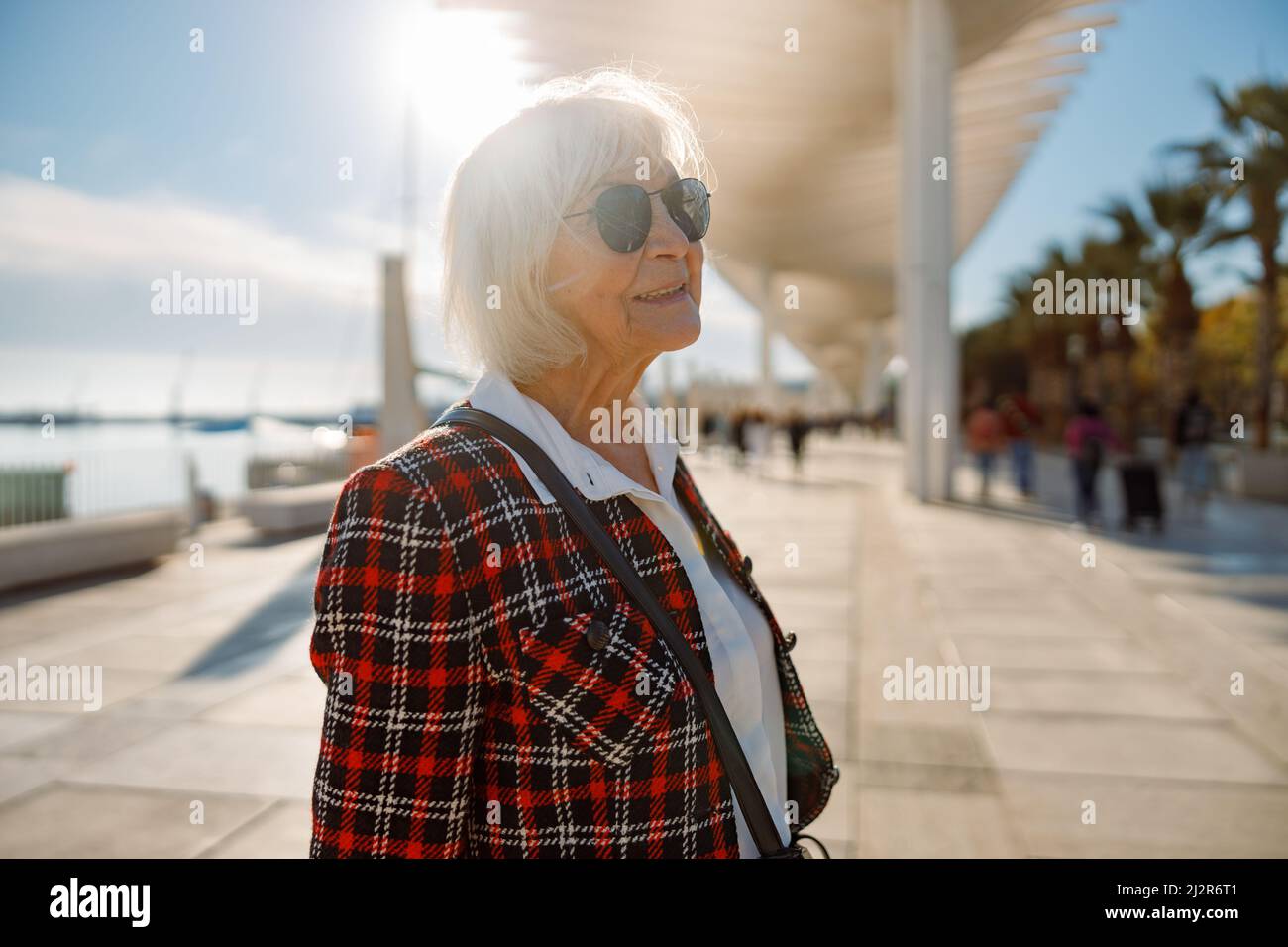 Busy senior lady taking stroll through city Stock Photo - Alamy