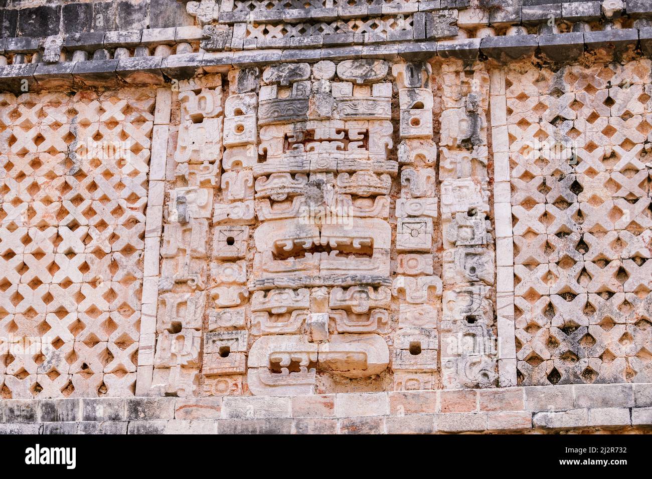 Stacks of three mayan masks on the wall of Nunnery Quadrangle (West ...