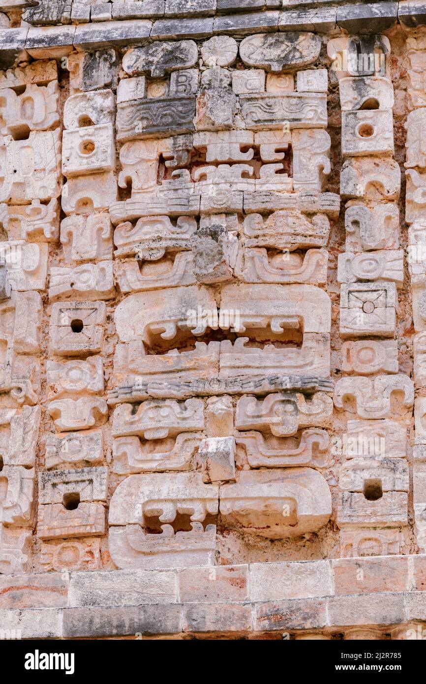 Stacks of three mayan masks on the wall of Nunnery Quadrangle (West ...