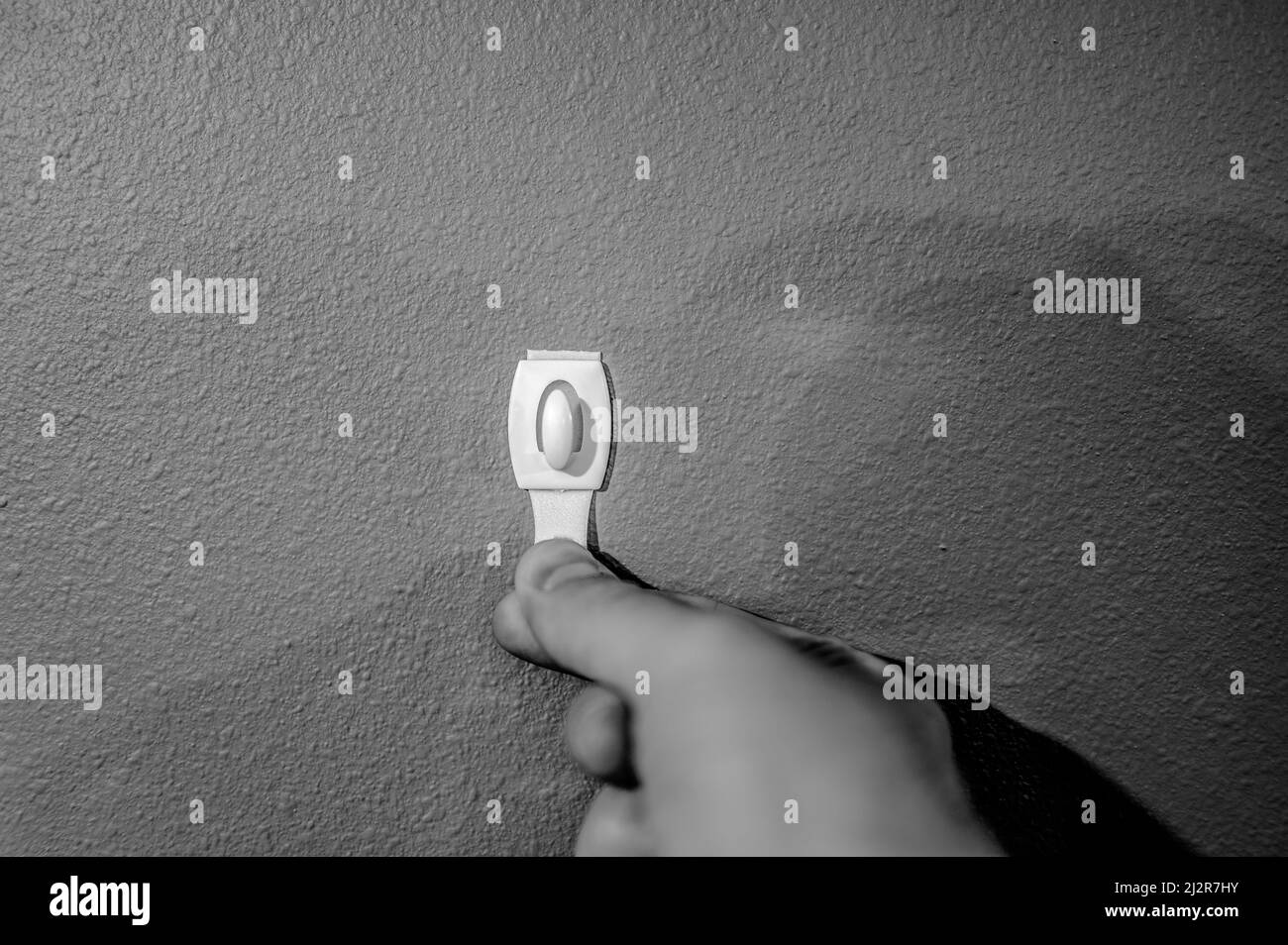 Selective focus on adhesive strip wall hanger that can be removed by ...