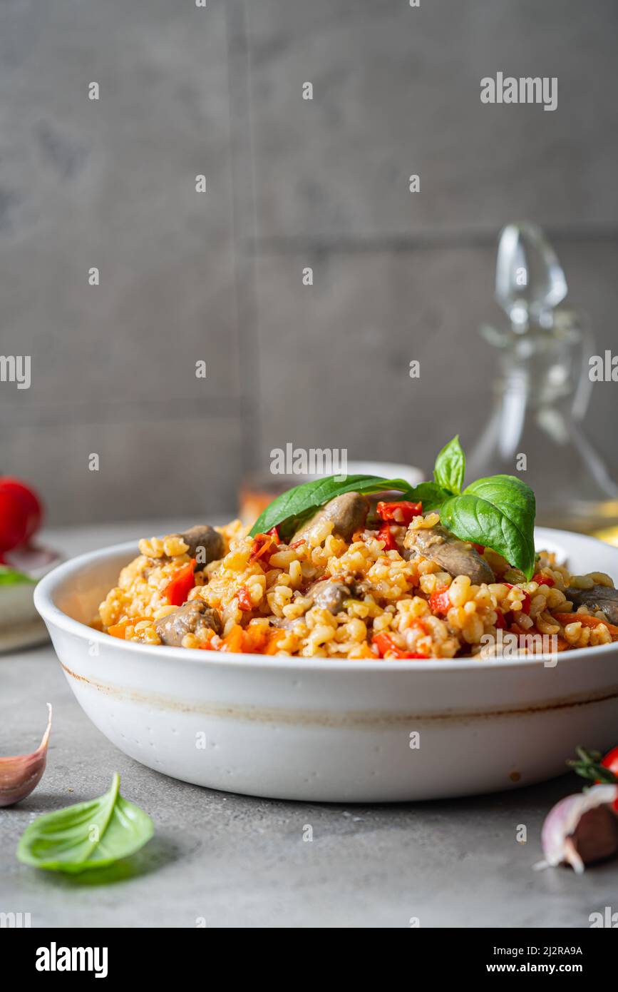 bulgur with chicken hearts and vegetables. Delicious healthy dish on a ...