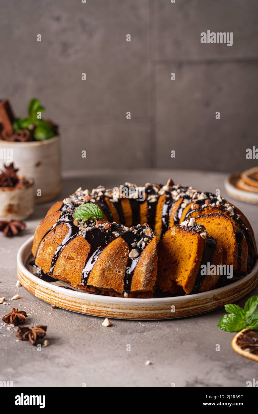 Vanilla bundt cake with chocolate glaze and nuts on top Stock Photo - Alamy