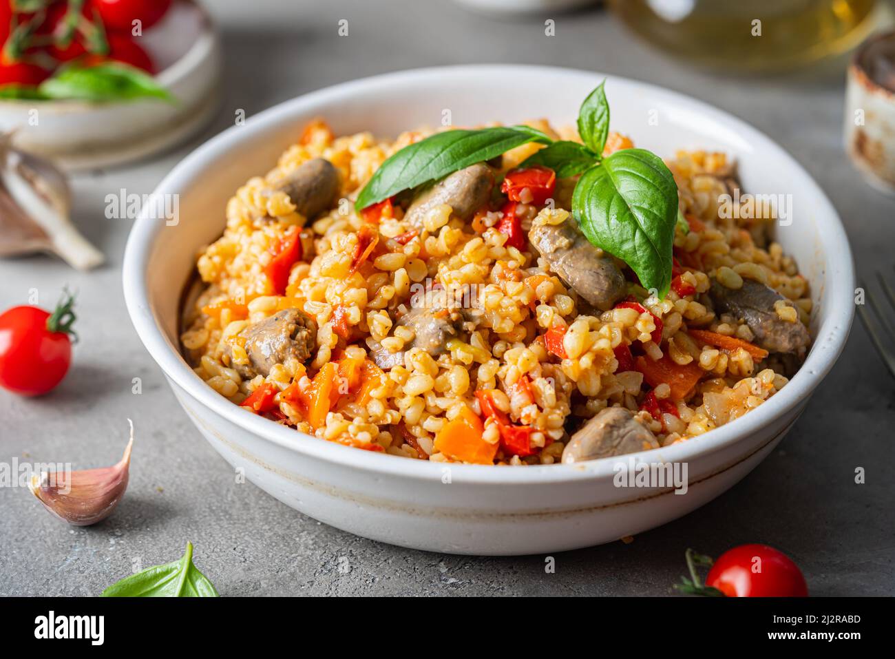 bulgur with chicken hearts and vegetables. Delicious healthy dish on a ...