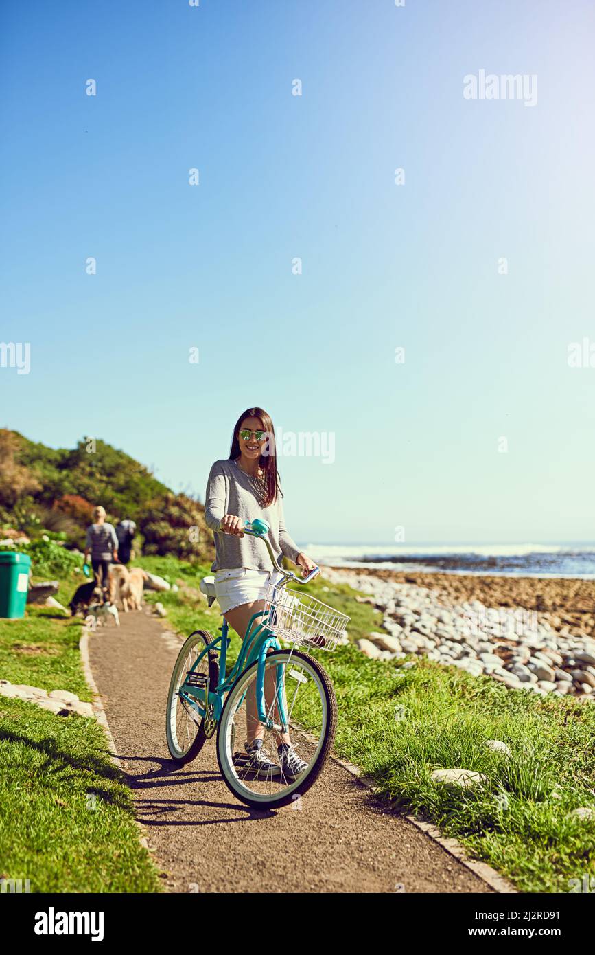 What a beautiful day for a bike ride. Portrait of an attractive young ...