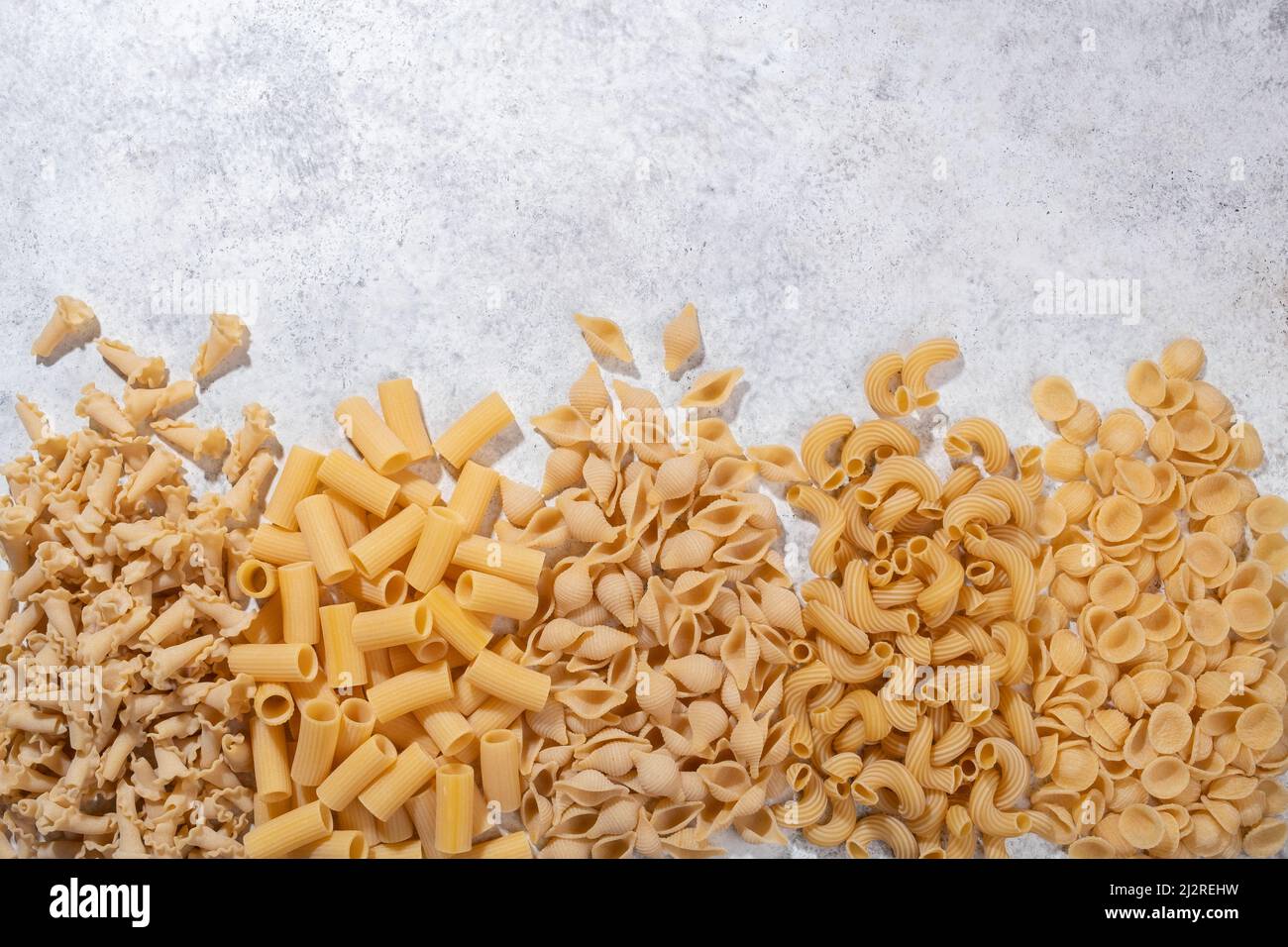 Different types of raw pasta on a textile background Stock Photo - Alamy