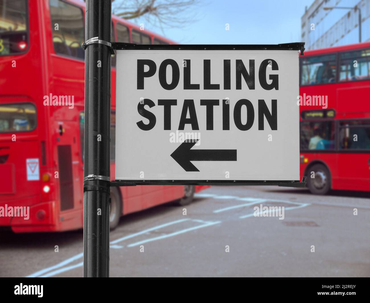 Polling station sign over double decker buses blurred background Stock ...