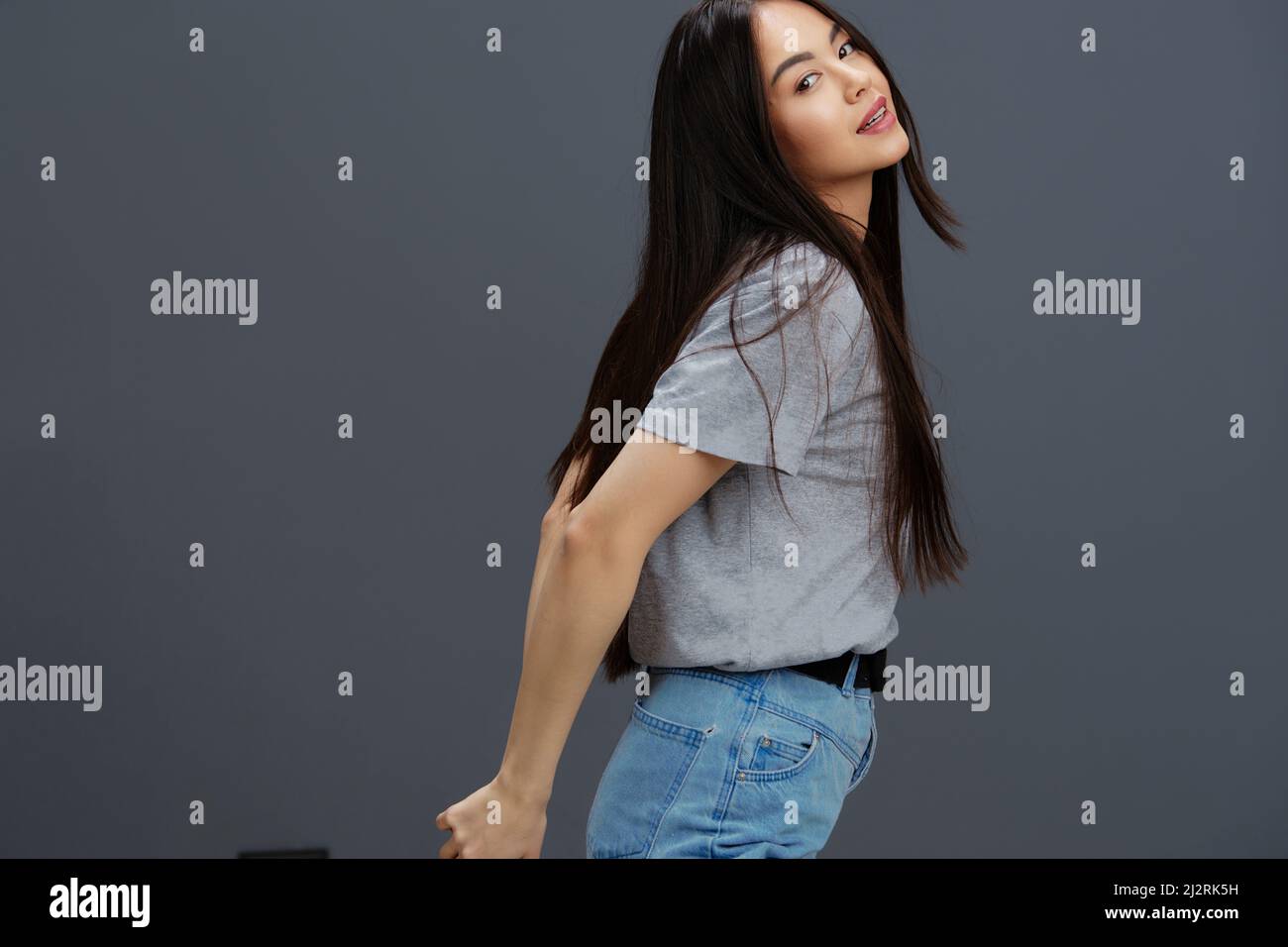 woman in a t-shirt and jeans posing Youth style studio model Stock Photo - Alamy