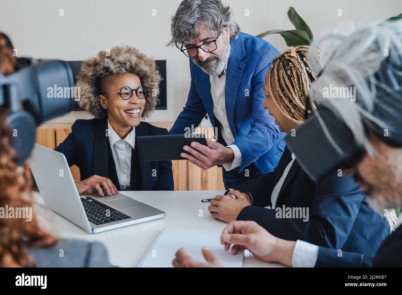 Business people using virtual reality goggles work with metaverse tech ...