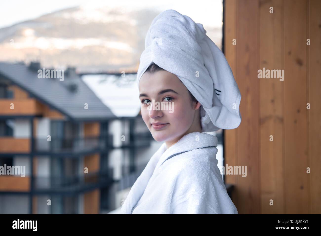 A Young Woman In A Bathrobe And With A Towel On Her Head After A Shower