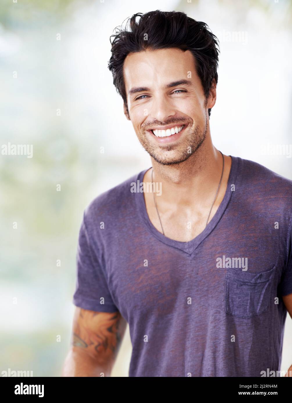 Hes got charm to go with those good looks. Portrait of a smiling ...