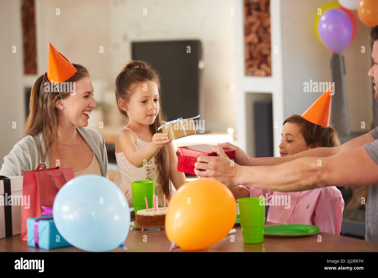 Ready to open her presents. Cropped shot of a family celebrating a ...