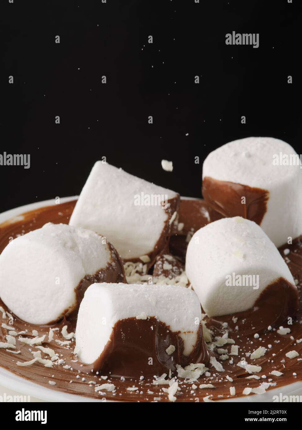 Macro shot. White marshmallow cubes in chocolate paste. Isolated on ...