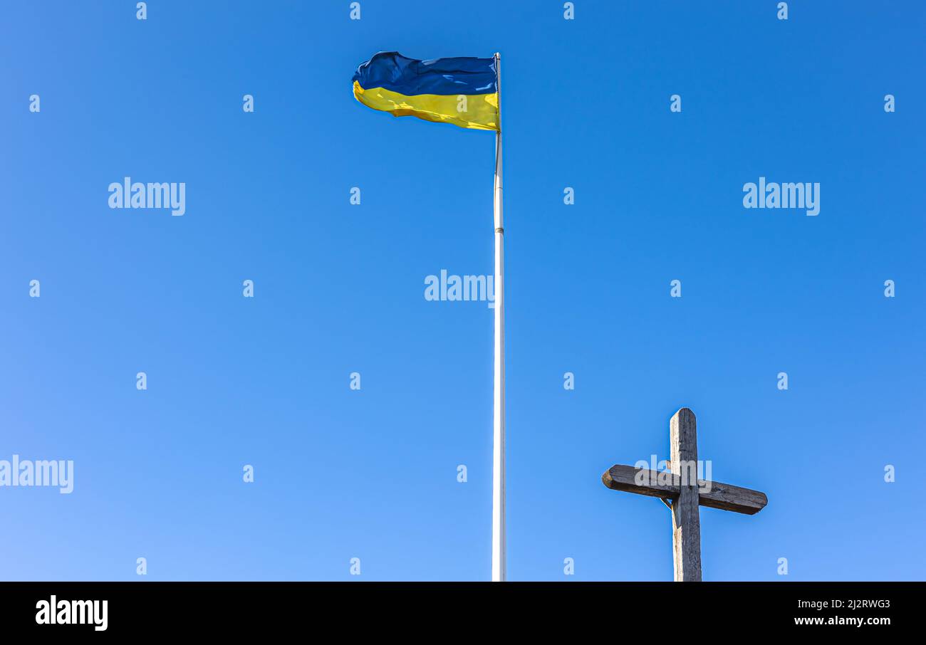 The crucifixion of Jesus Christ and the flag of Ukraine against the ...