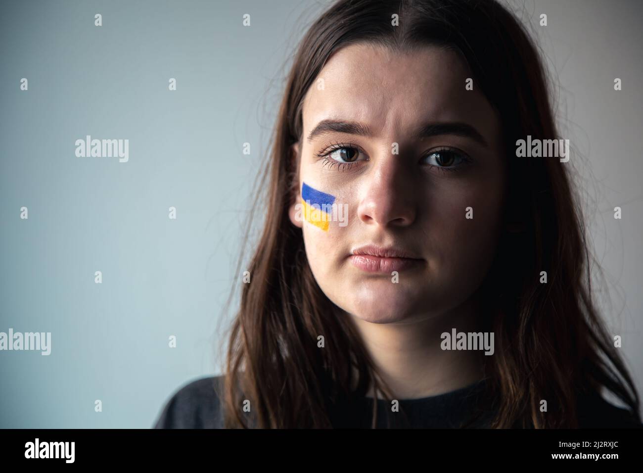 A Ukrainian girl with a painted flag of Ukraine on her face Stock Photo ...