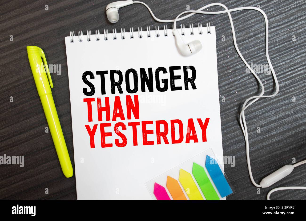 stronger than yesterday white chalk text on a vintage slate blackboard ...