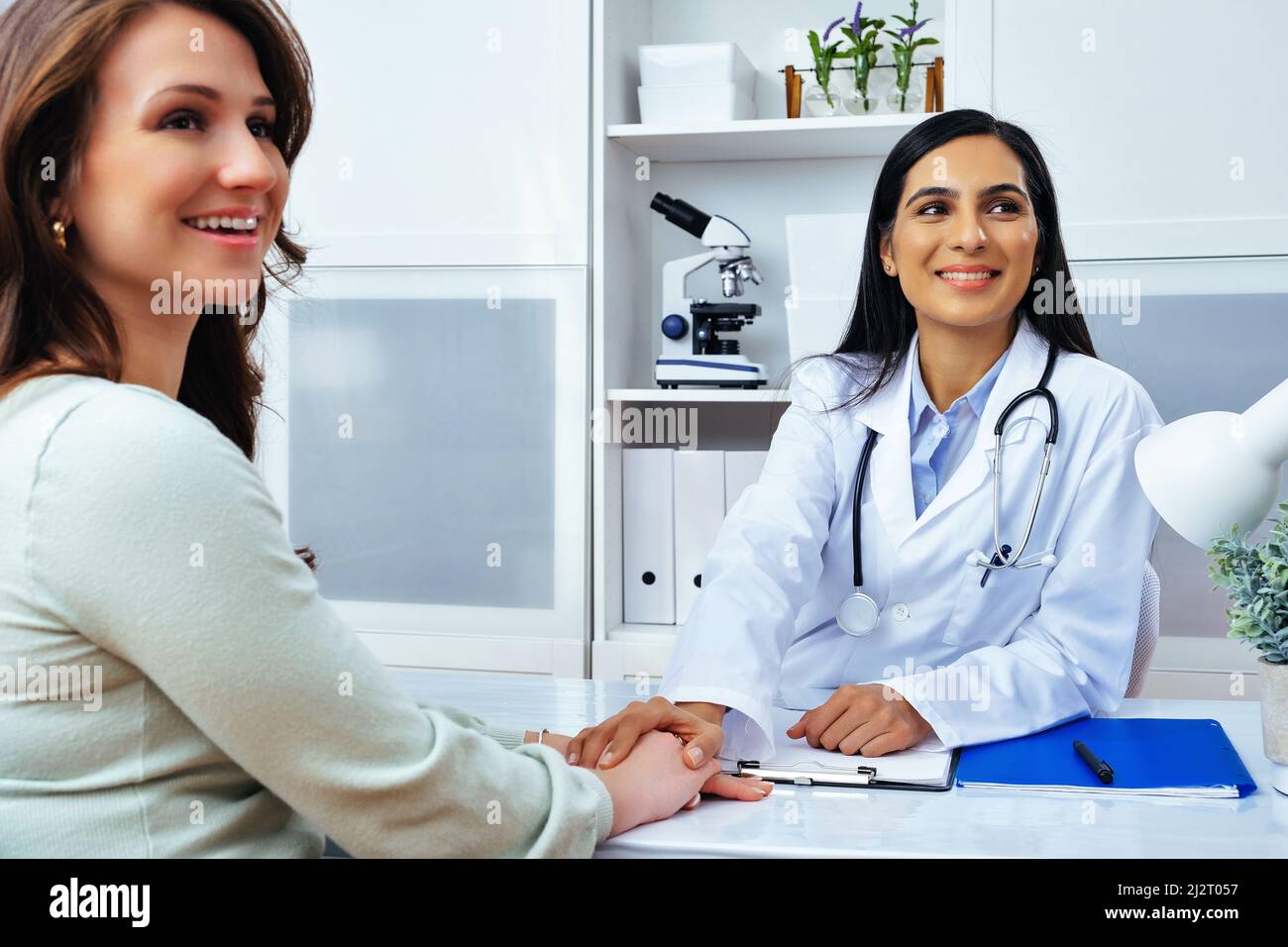 Young lady client patient visiting pleasant attentive female doctor ...