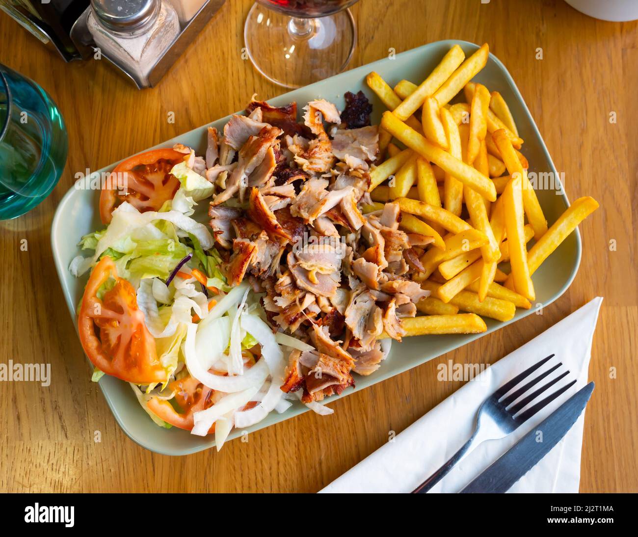 Dish Doner kebab with French fries and a light vegetable salad Stock ...