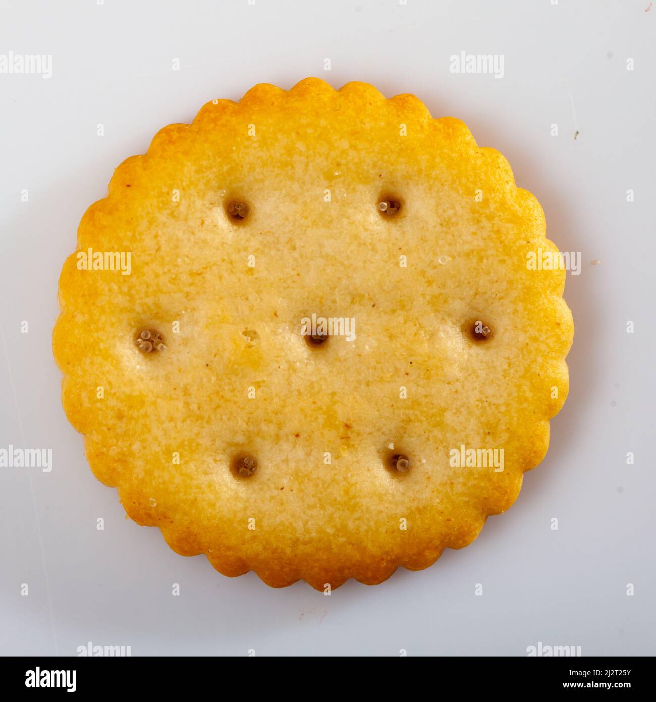 Crispy salted round cracker on white table Stock Photo - Alamy
