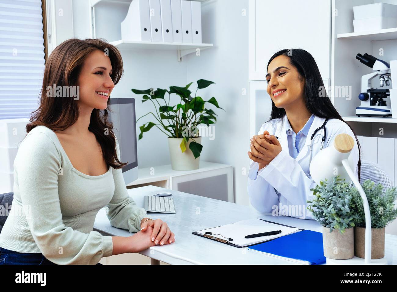Young lady client patient visiting pleasant attentive female doctor ...