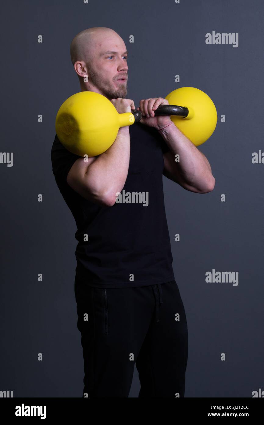 Guy with a yellow kettlebell gym anonymous yellow male, in the ...