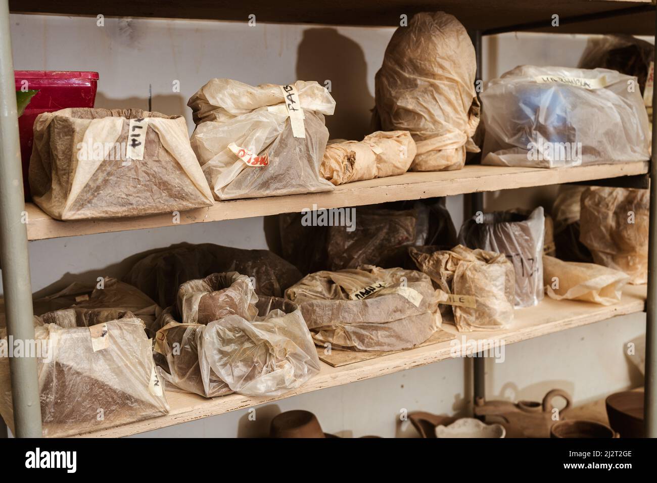 Shelves with packages or bags with handmade pieces of clay until they ...