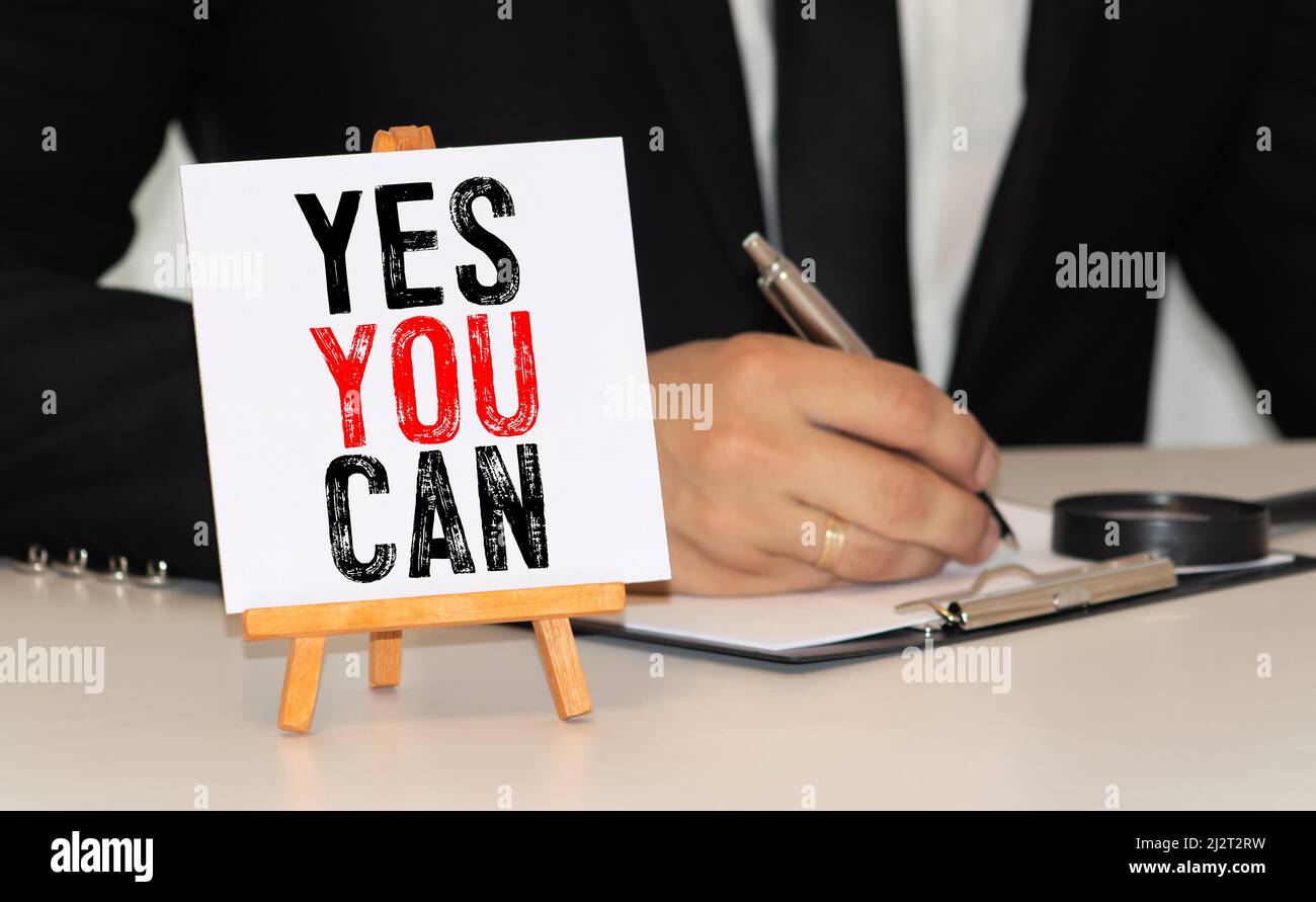 YES YOU CAN. Woman holding blackboard in hands with text YES YOU CAN ...
