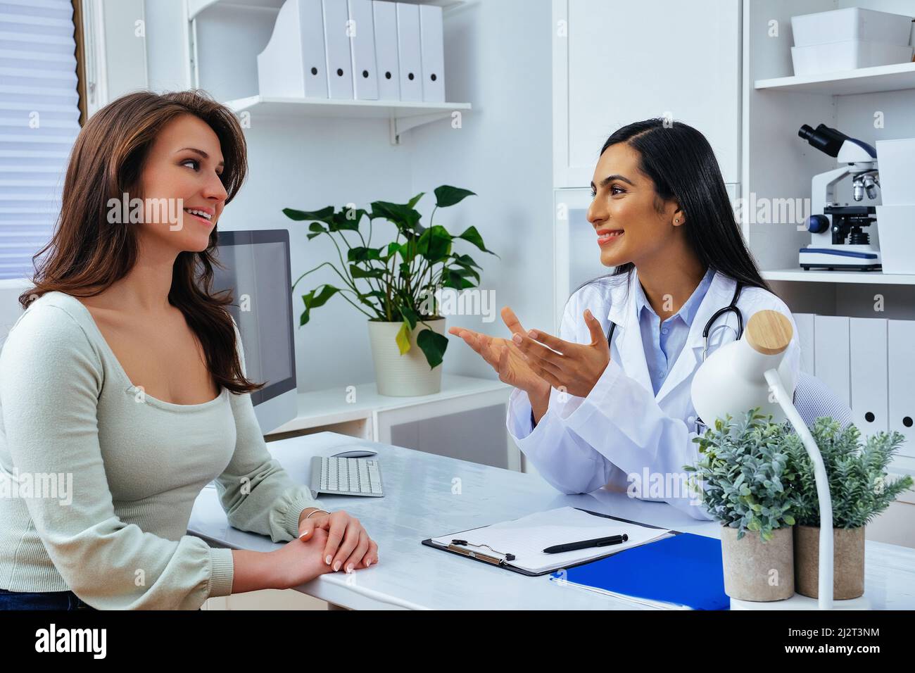 Young lady client patient visiting pleasant attentive female doctor ...