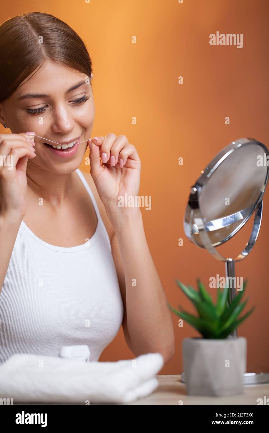 Smiling women use dental floss white healthy teeth Stock Photo - Alamy