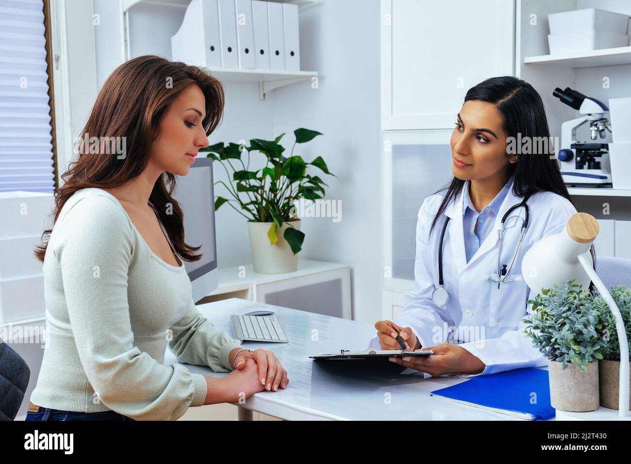 Young lady client patient visiting pleasant attentive female doctor ...