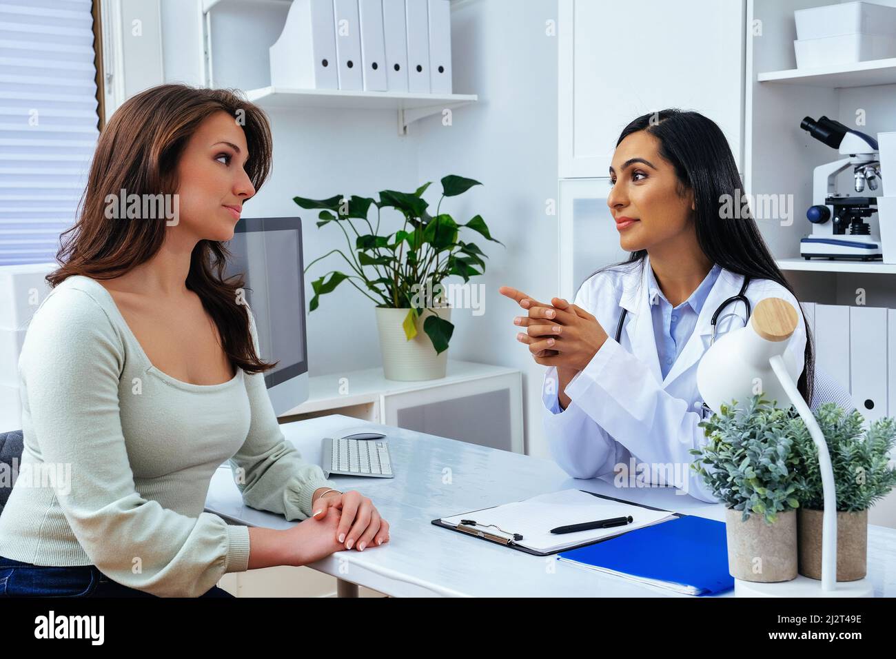 Young lady client patient visiting pleasant attentive female doctor ...