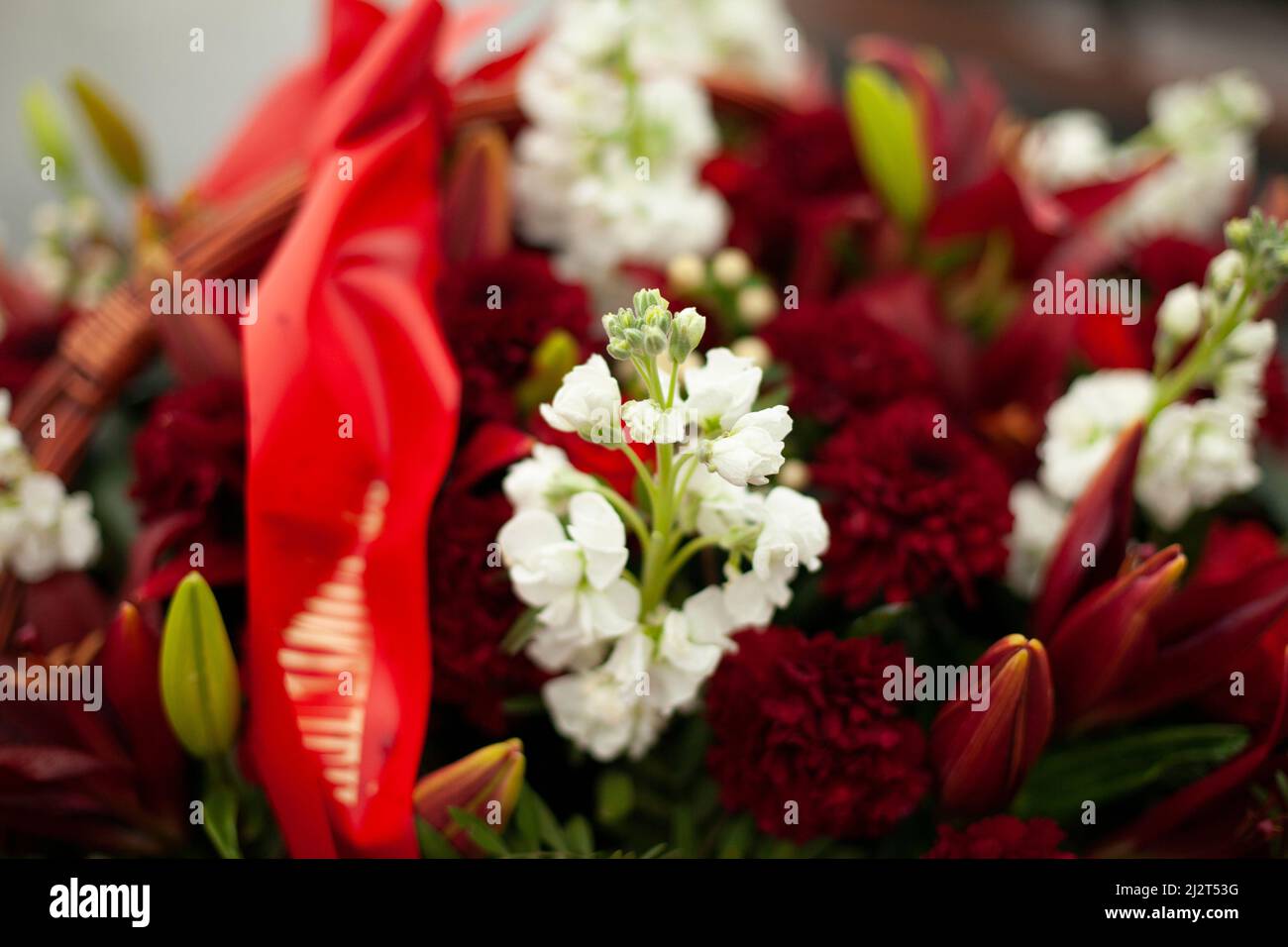 Flowers on monument. Artificial flowers on memorial. Solemn wreath on ...