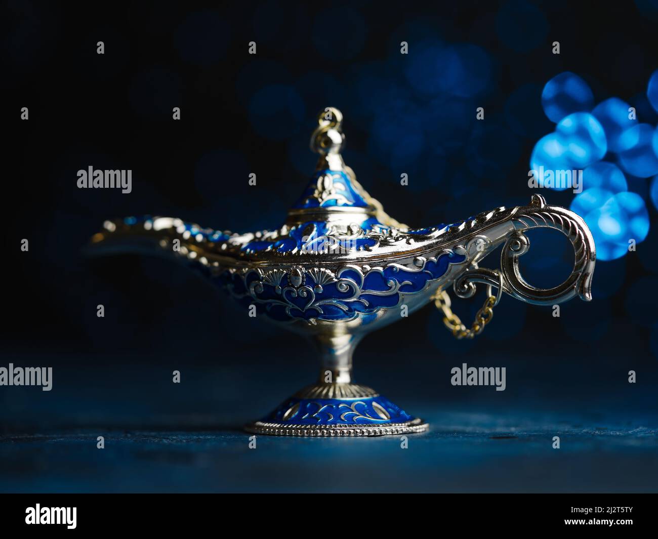 Aladdin's magical lamp, jeweled on a blue background. Arabian fairy ...