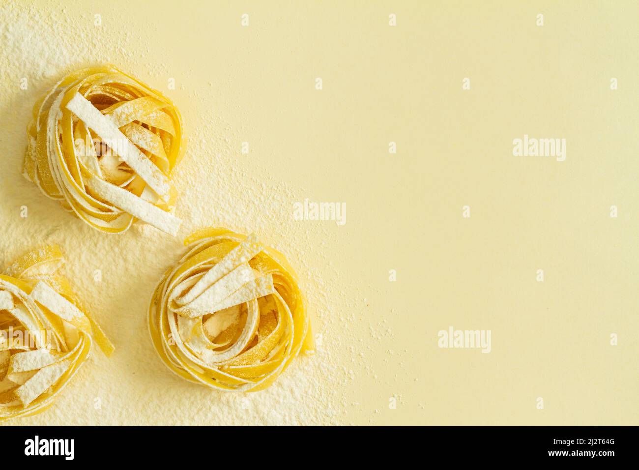 Flat lay top view fettuccine pasta on a yellow pastel background copy ...