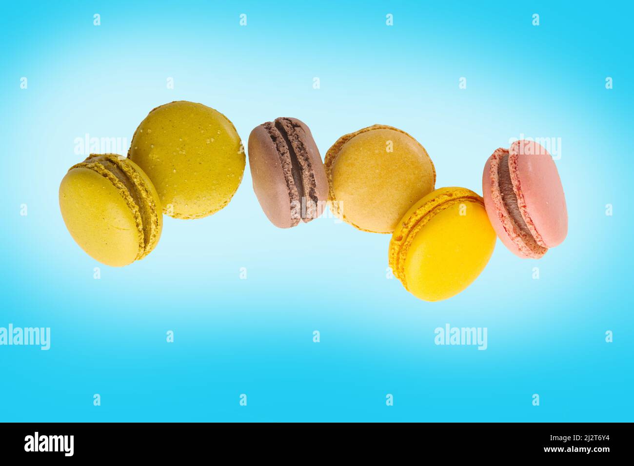 Traditional French sweets - multi-colored macaroons on a pale blue ...