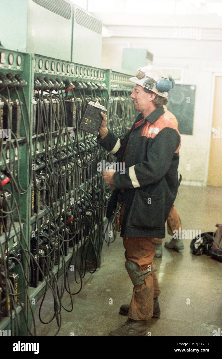A miner returns his lamp to the lamp room for the final time as the ...