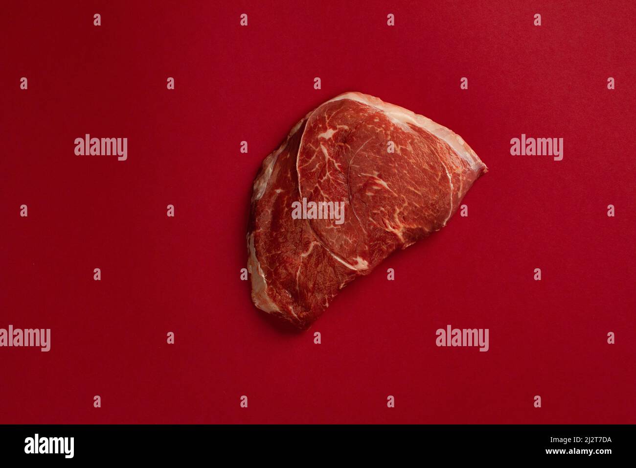 Raw beef meat steak isolated on a blood background Stock Photo - Alamy