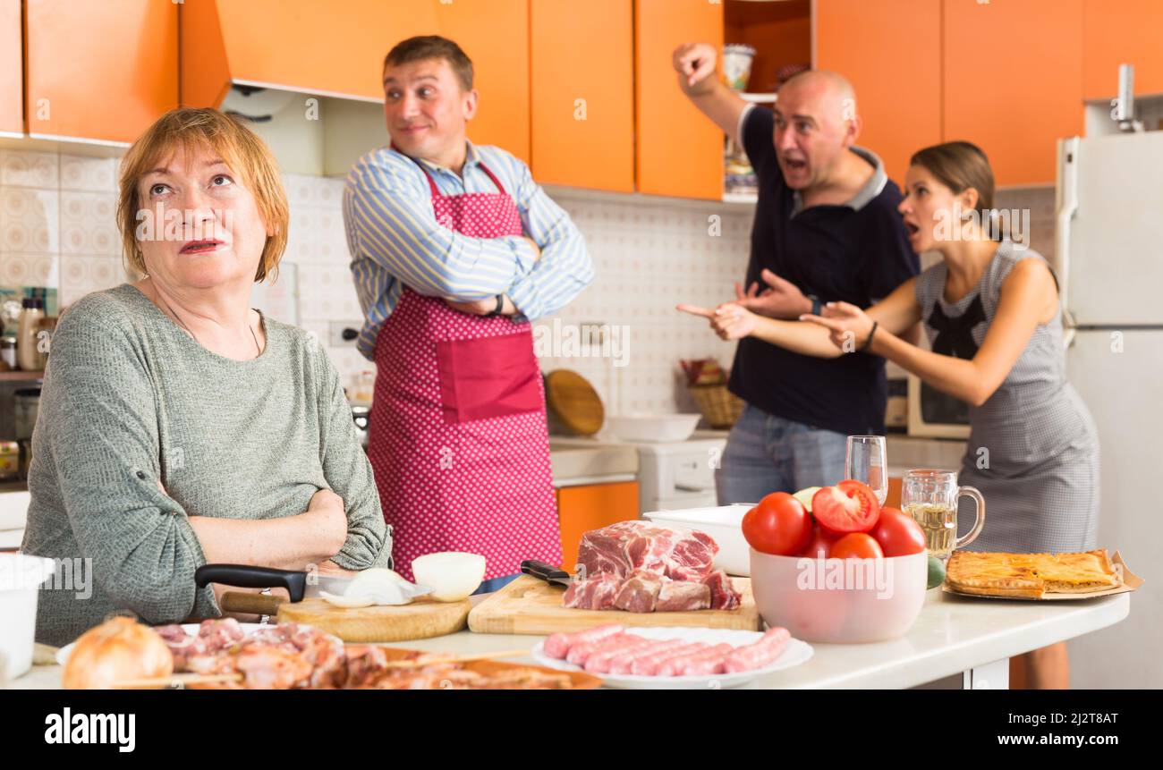 Family members having conflict in kitchen Stock Photo - Alamy