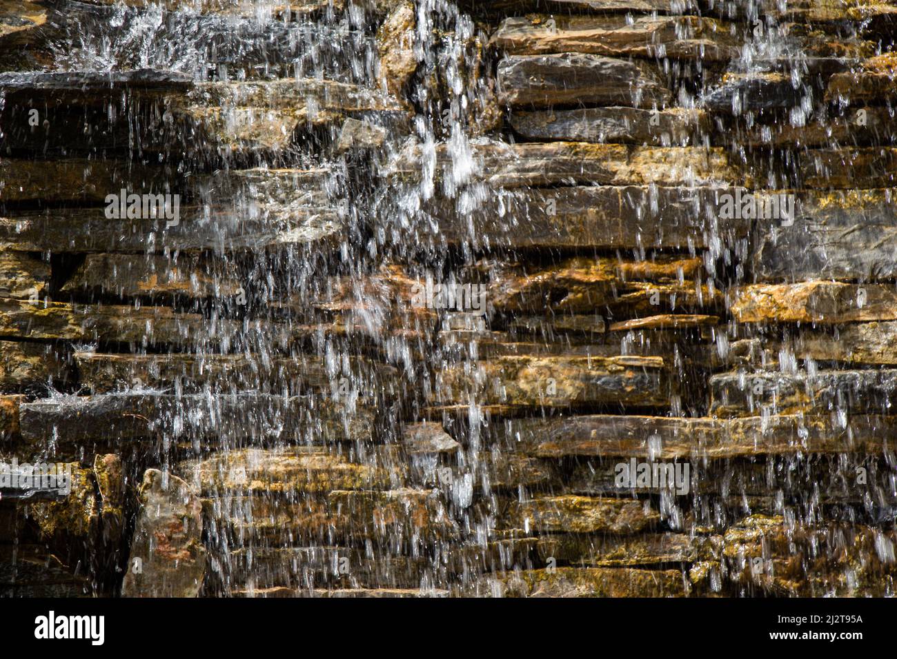 Small rocky waterfall pouring into a small pool Stock Photo - Alamy