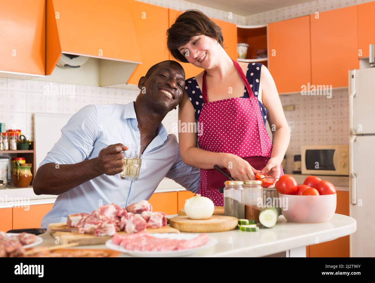 Couple making meat dinner Stock Photo - Alamy