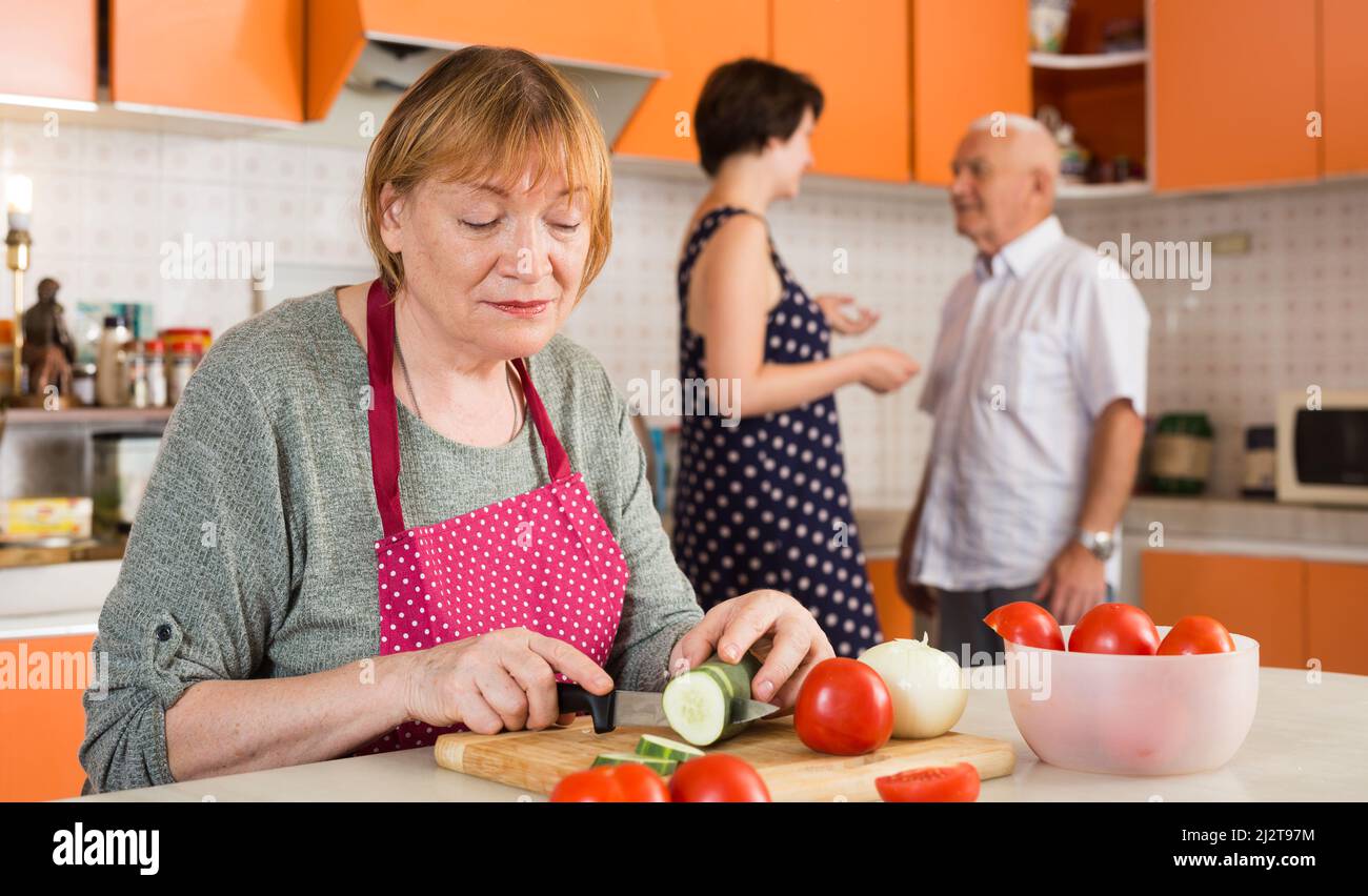 Mature woman cooking busy hi-res stock photography and images - Alamy