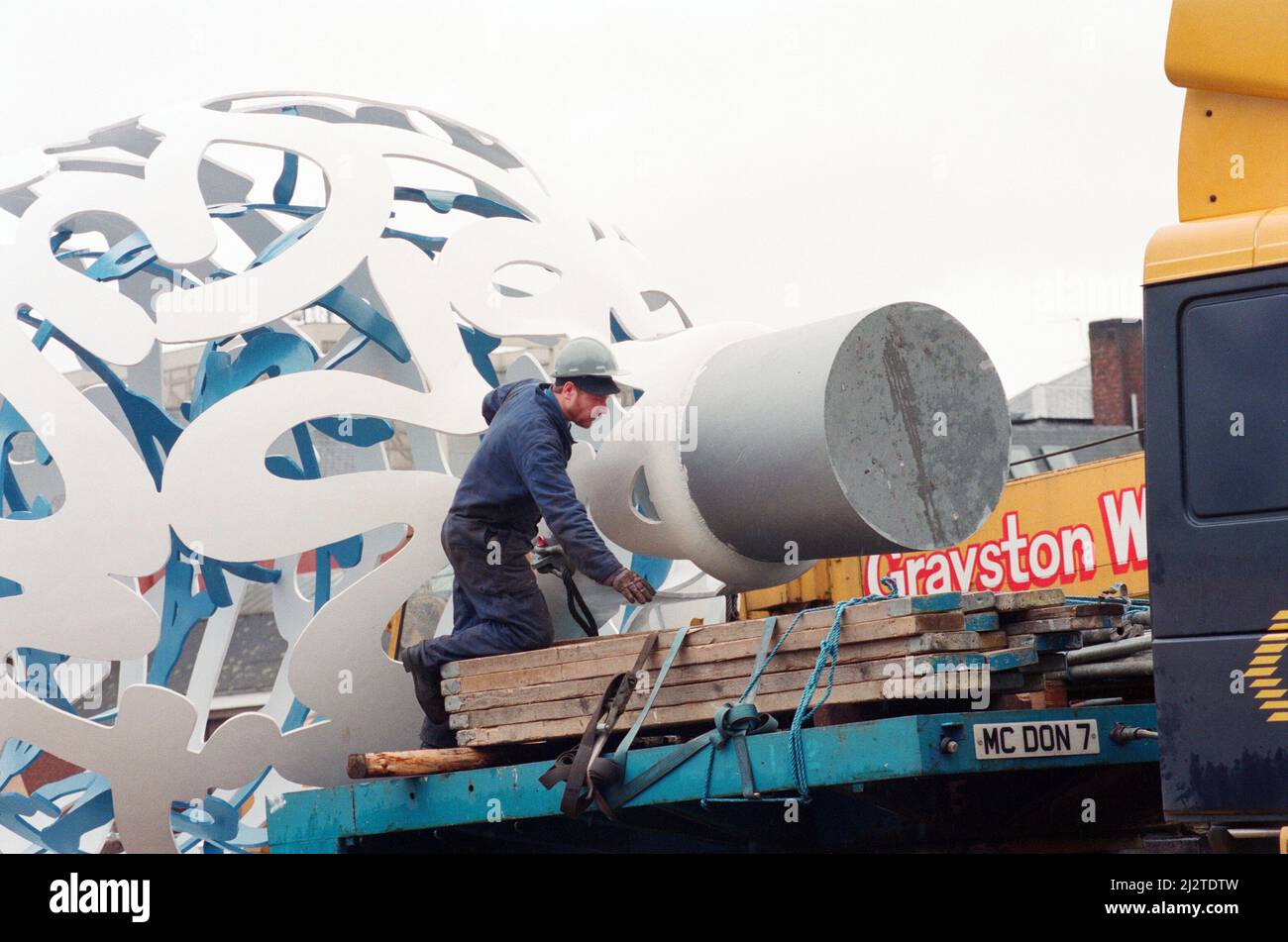 The sculpture 'Bottle of Notes' is lifted off its low loader in the ...