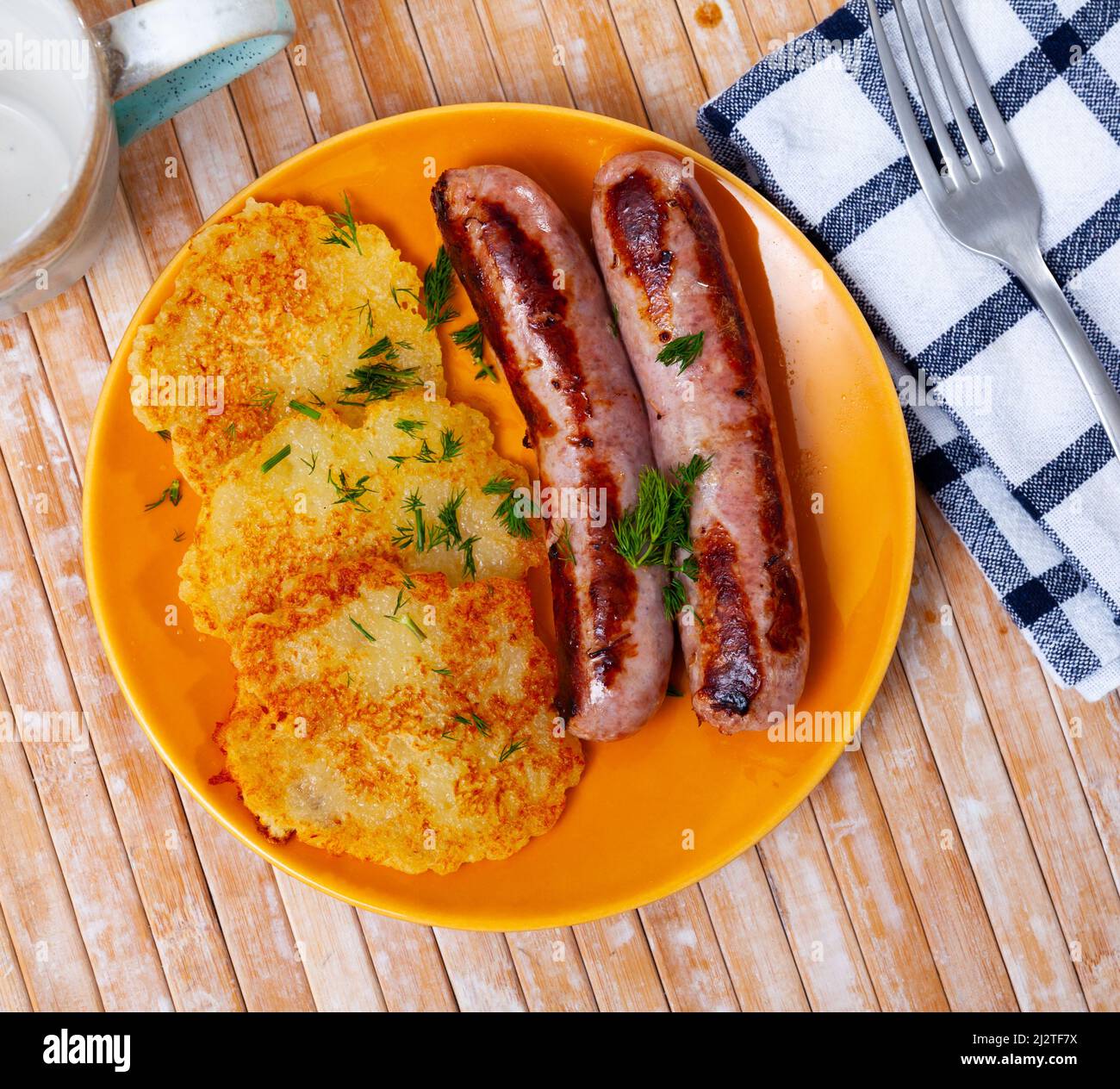 National dish of Belarusian cuisine is draniki with fried sausages ...